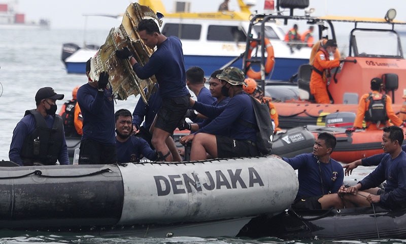 Day after plane with 62 on board crashed, Indonesian divers find ...