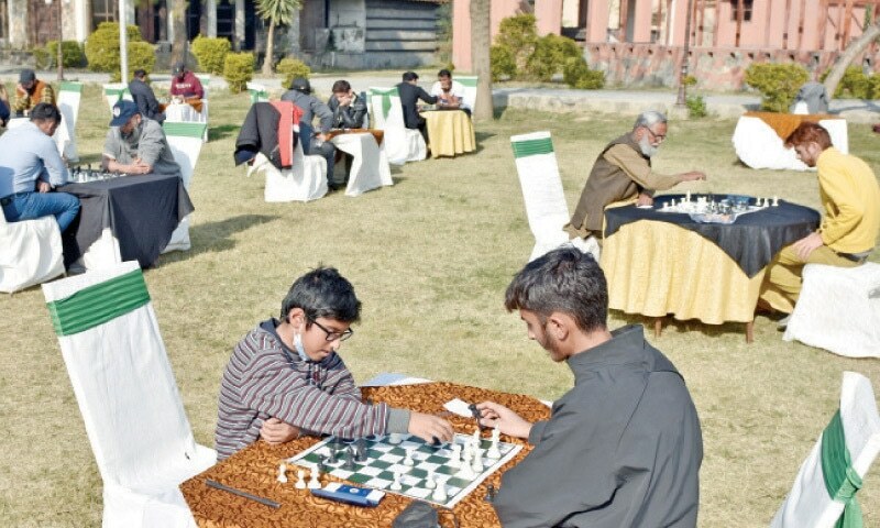 Citizens soak up the sun amid crafty moves in board games - Newspaper ...
