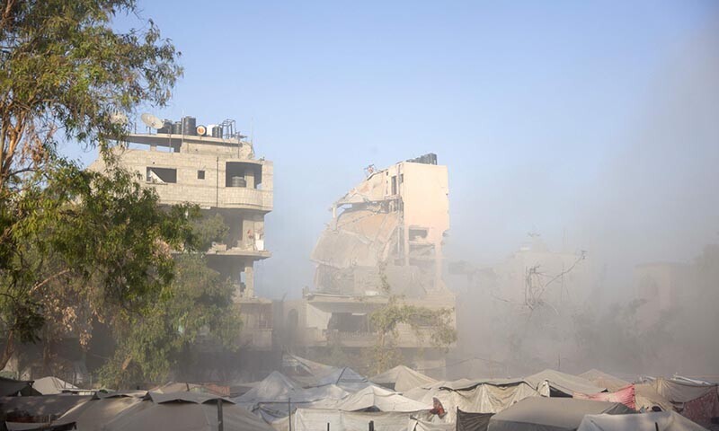 PHOTOS: Palestinians gather at site of Israeli strikes on six-storey ...