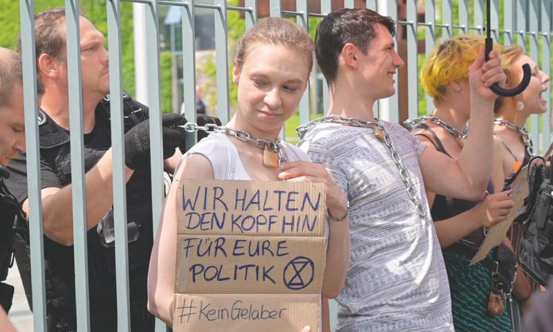 Climate protesters chain themselves to Merkel’s chancellery - Newspaper ...