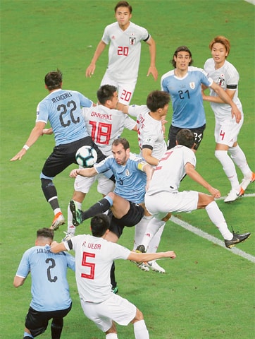 Uruguay fight back against Japan with help of VAR controversy ...
