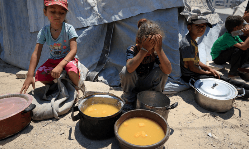 Palestinians gather to receive food from charity kitchen amid hunger ...